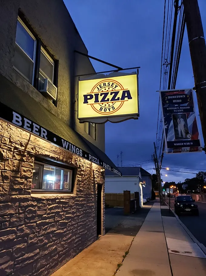 Jersey Pizza Boys' illuminated sign cuts through the night – a bat signal for those seeking serious pizza satisfaction.