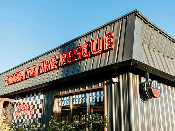"Pizza To The Rescue" isn't just a clever name—it's a promise delivered in neon. The black and white checkerboard facade adds a touch of retro charm.