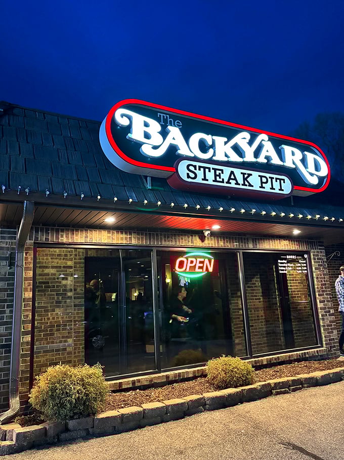 The Backyard Steak Pit's neon glow is like a lighthouse for the carnivorous soul on a hungry night.