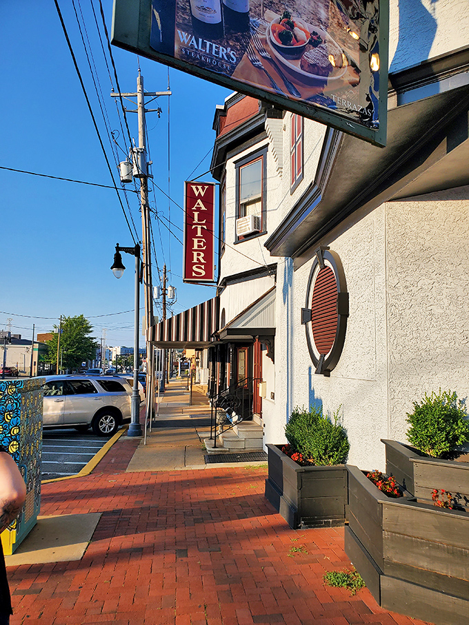 Walter's Steakhouse sign stands proud against Wilmington's blue sky. A carnivore's North Star guiding you to beefy bliss.
