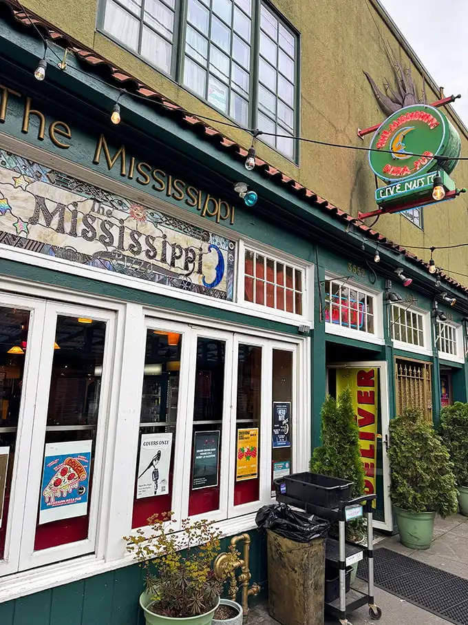 That mosaic sign isn't just decoration – it's a colorful preview of the creative pizza artistry waiting inside.