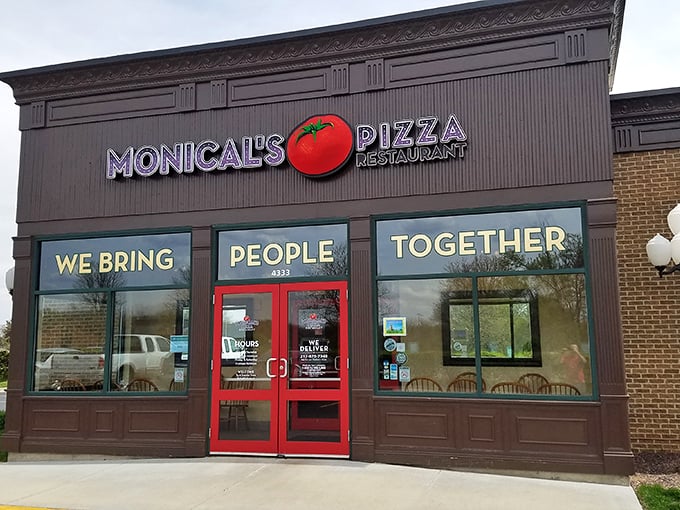 That bright red tomato logo against Monical's brown facade is like a beacon calling all hungry pizza pilgrims.