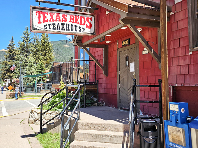 That weathered sign and rustic entrance at Texas Reds – where mountain charm meets serious steak business. Your stomach is already applauding.