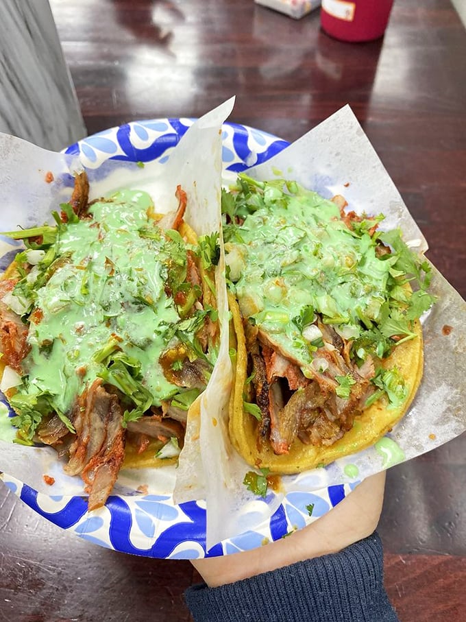 These adobada tacos aren't just food—they're little flavor bombs topped with a green sauce that should be illegal in at least 12 states.
