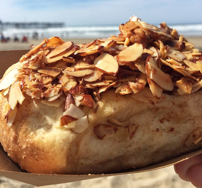 Toasted almonds crown this golden masterpiece like nature's sprinkles. The beach backdrop makes this the ultimate California breakfast of champions.