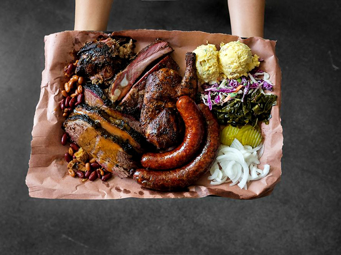 Behold the barbecue Holy Trinity—where brisket, ribs, and sausage converge on butcher paper to create what can only be described as meat nirvana.