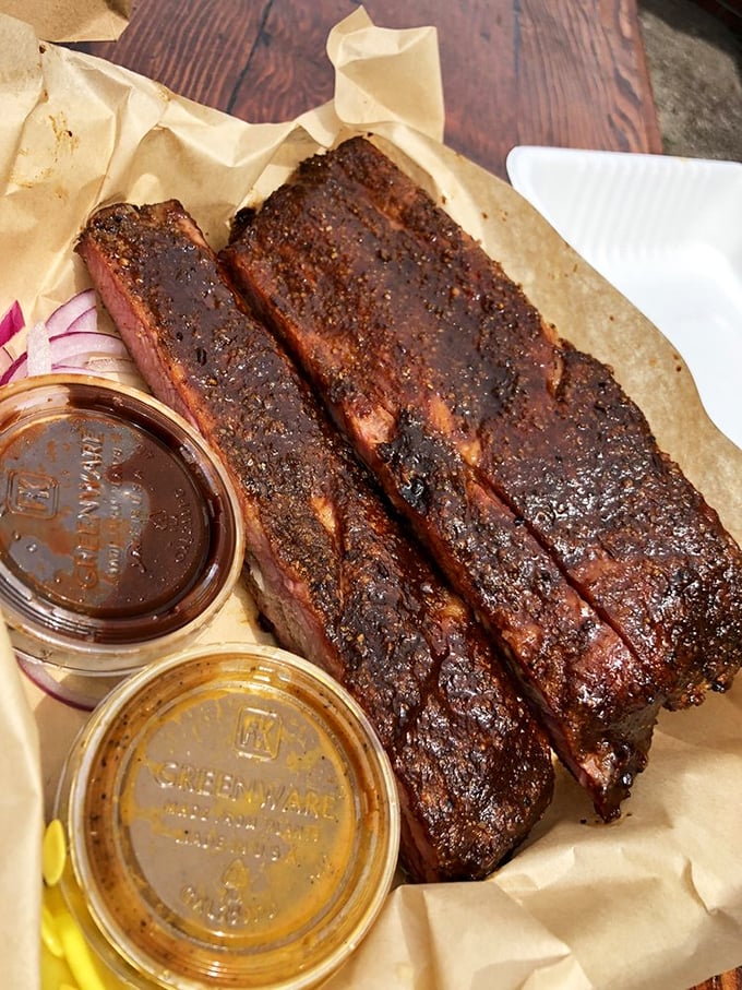 These ribs don't just fall off the bone—they practically leap into your mouth, their bark glistening with promise and smoky glory.