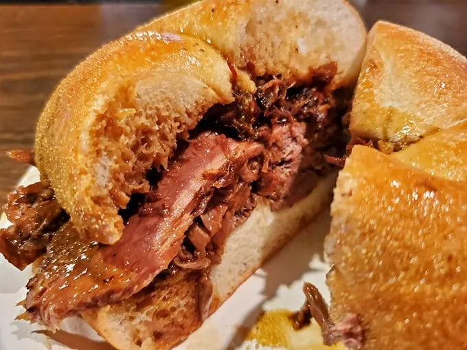 This isn't just a sandwich—it's a masterpiece of meat architecture, with perfectly pink roast beef nestled in a roll that's seen the jus.