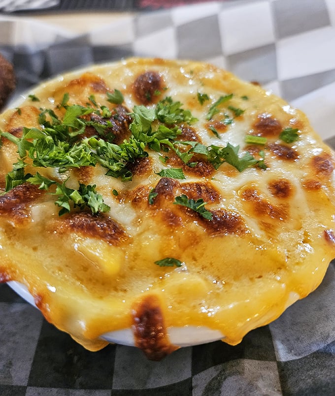 Golden, bubbling perfection in ceramic form. This mac and cheese doesn't just satisfy hunger—it resolves existential crises one cheesy bite at a time.
