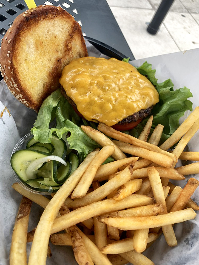 This isn't just a cheeseburger—it's a masterpiece of melted American cheese cascading over perfectly seared Colorado beef, with fries standing by for backup.