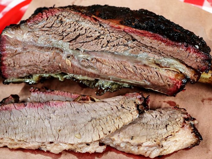 Behold the beef rib—a prehistoric-looking masterpiece that makes Fred Flintstone's car-tipping portion look like an appetizer. Carnivore nirvana achieved.