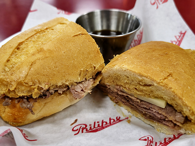 Tender beef piled high on crusty bread, ready for its transformative dip in liquid gold. 