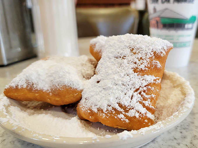 Powdered sugar mountains that would make Walter White jealous. These golden pillows of fried perfection are Louisiana's answer to meditation—forcing you into delicious presence.