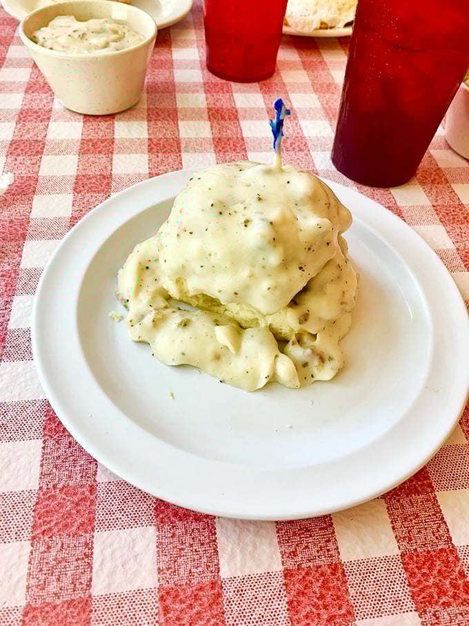 Behold: gravity-defying biscuits drowning happily in a sea of peppery gravy. Breakfast architecture at its finest.