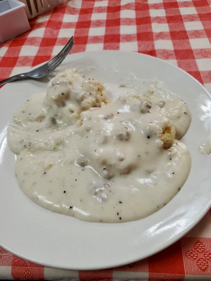 Biscuits drowning in creamy, pepper-flecked gravy—a breakfast so comforting it should come with a warning: "May induce spontaneous sighs of contentment."