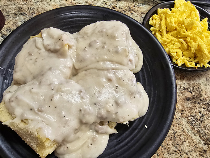 Biscuits swimming in creamy pepper gravy alongside scrambled eggs—a Southern breakfast so comforting it's basically a warm hug on a plate.