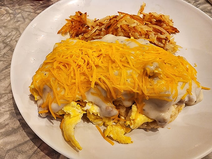 This isn't just breakfast, it's edible architecture – layers of gravy, cheese and eggs creating a savory skyscraper of satisfaction.