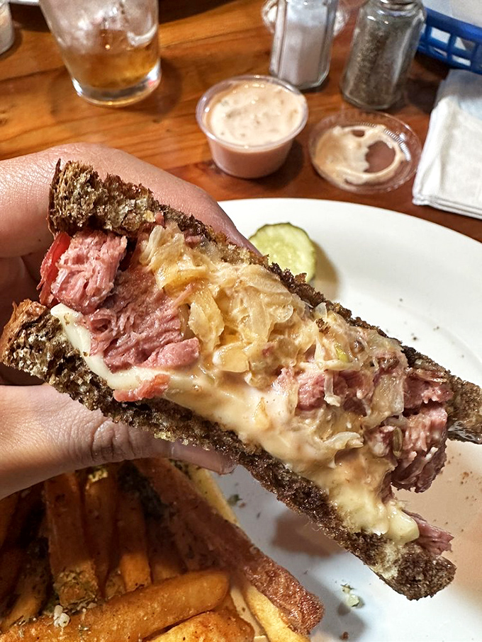 Behold the Blackstone Reuben in all its glory—corned beef, sauerkraut, and Swiss cheese performing a perfect harmony between marble rye.
