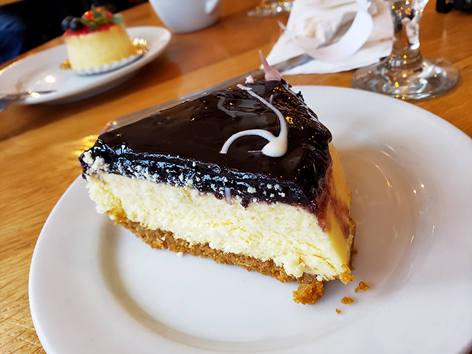 This blueberry-topped cheesecake isn't just dessert—it's a religious experience with a graham cracker crust congregation and chocolate ganache choir.