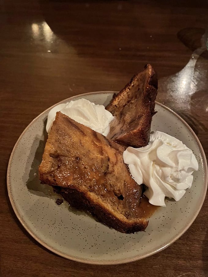 Bread pudding that could make a dessert skeptic weep with joy. That golden crust, that tender interior, those dollops of cream—resistance is futile.