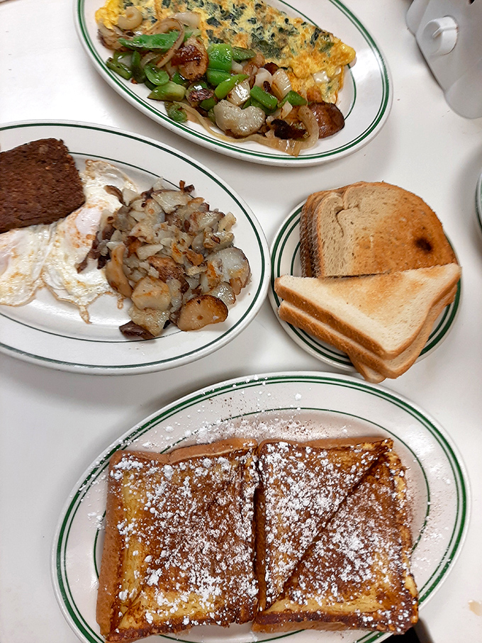 Breakfast perfection on a plate: golden omelets, crispy home fries, and toast waiting patiently for its butter bath.