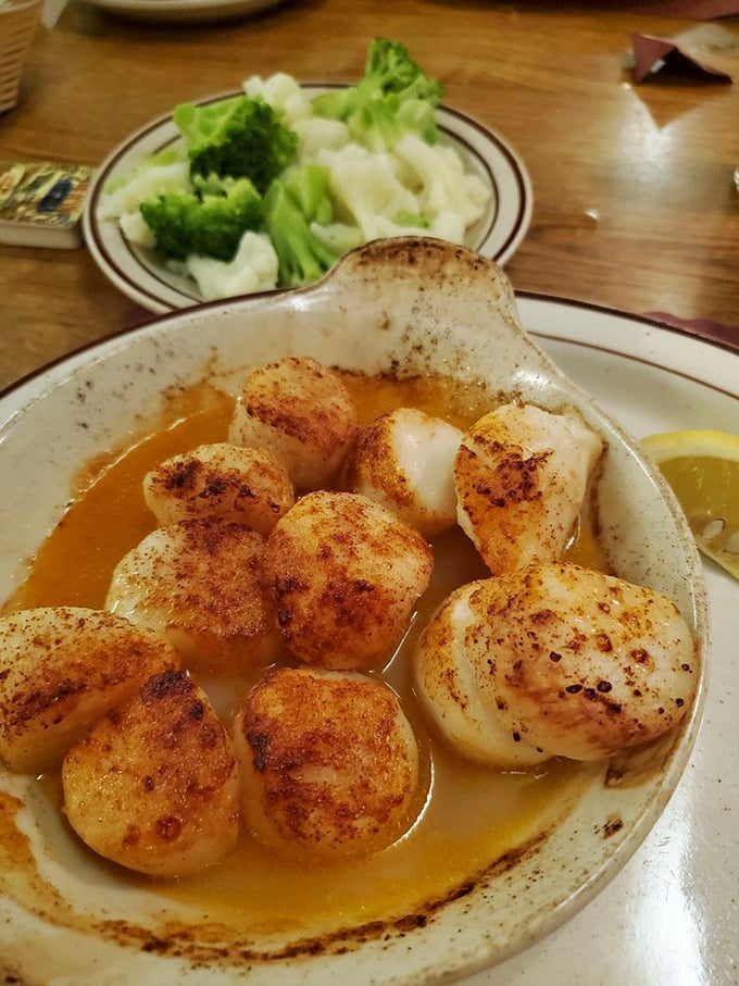 These scallops aren't just seared, they're practically bronzed—glistening in buttery sauce like Olympic medals for your taste buds.