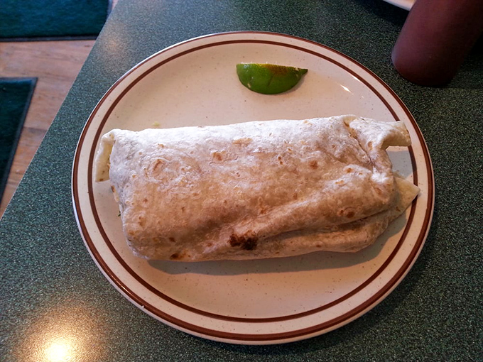 This burrito isn't just a meal; it's an engineering marvel of perfectly balanced ingredients wrapped in a tortilla that deserves its own architectural award.