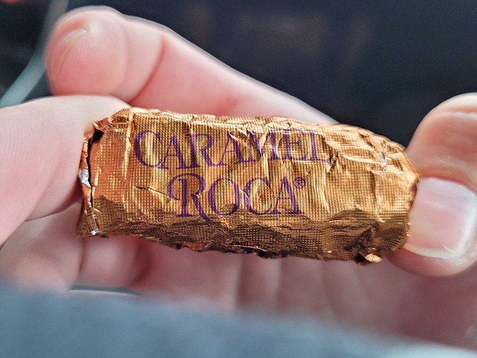 The gold-wrapped glory of Almond Roca in its natural habitat – between someone's fingers, moments before disappearing forever.