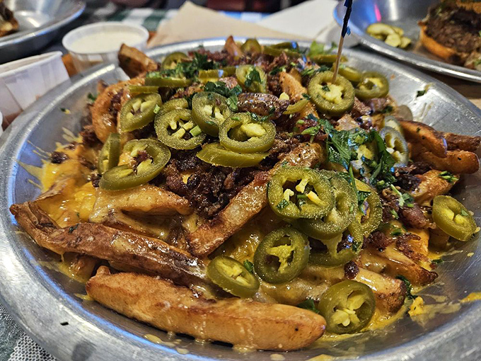 Not just fries, but a canvas for jalapeño artistry. These hand-punched potatoes wearing melted cheese and peppers are what dreams are made of.