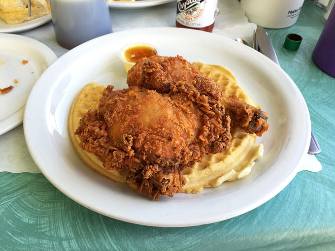 Golden-fried chicken perched atop a perfectly cooked waffle – a marriage so harmonious it deserves its own romantic comedy soundtrack.