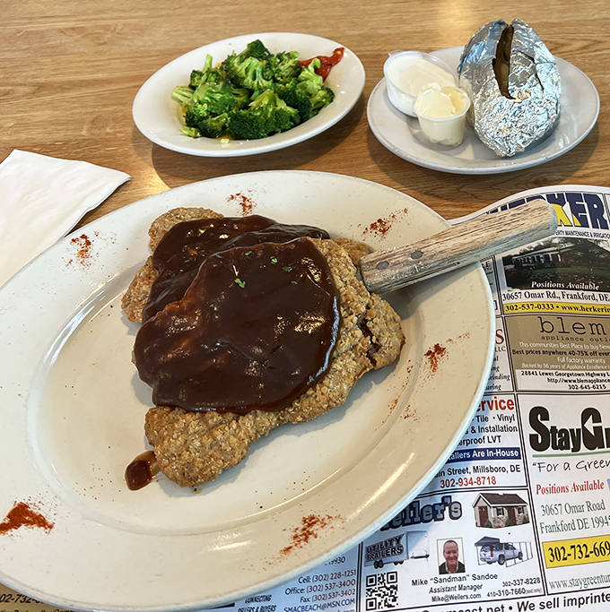 Behold the star attraction: country fried steak swimming in gravy that should be bottled and sold as therapy. The broccoli side is just there to ease your conscience.