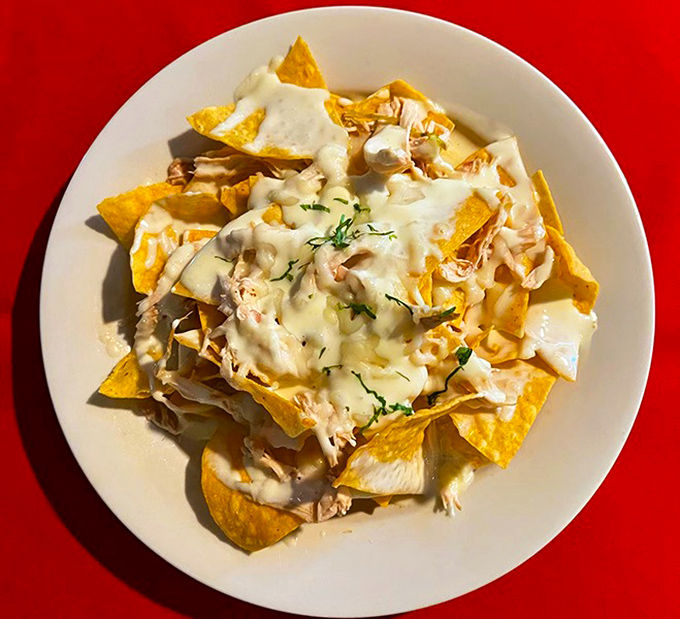 These nachos aren't just a snack—they're an architectural marvel of crispy chips, melty cheese, and chicken that had a higher calling than fast food.