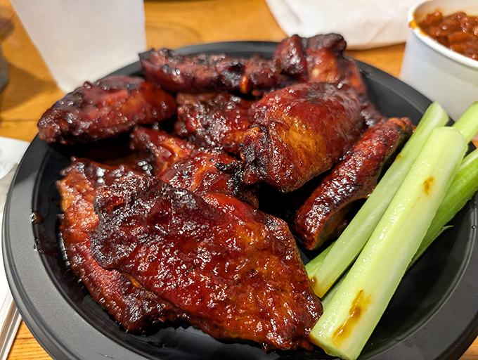 These glazed wings glisten like amber jewels, promising sticky fingers and pure satisfaction ahead.