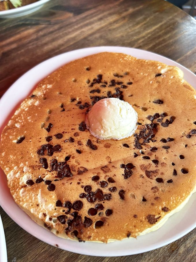Chocolate chip pancakes that make you question why you ever settled for cereal. That pat of butter slowly melting is nature's perfect timer.