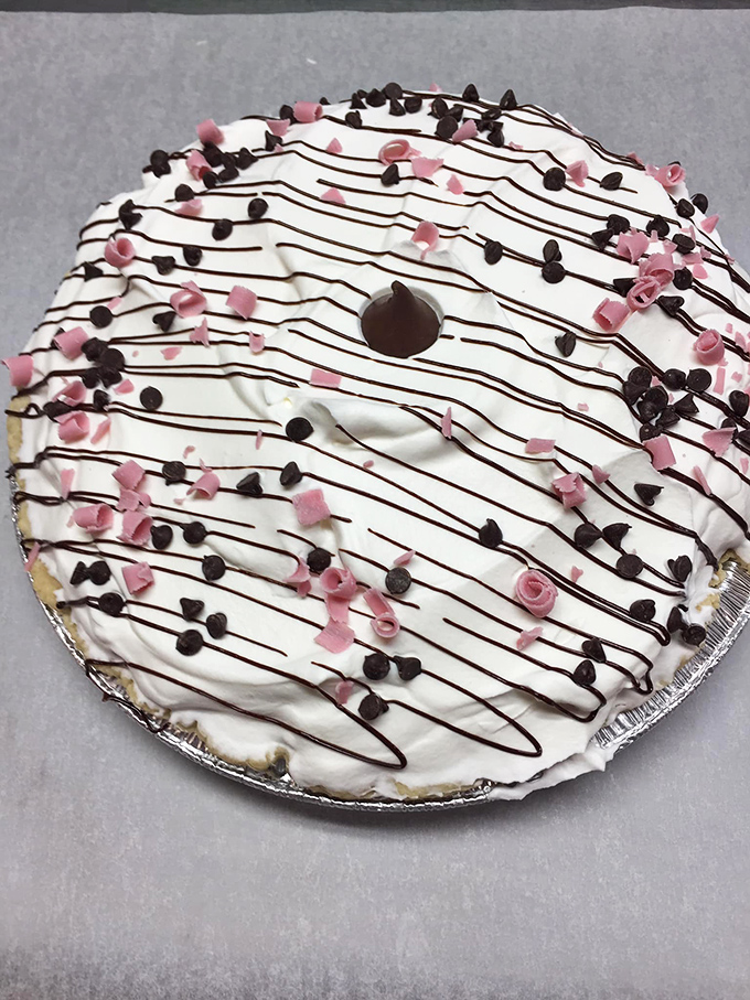 This chocolate cream pie isn't just dessert—it's therapy. The artful chocolate drizzle suggests someone in the kitchen actually cares about your happiness.