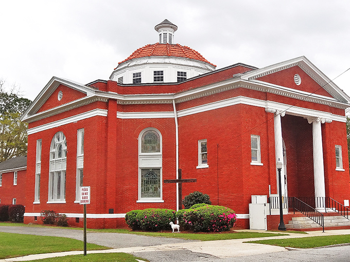 This stunning red brick church isn't just a building—it's the architectural equivalent of Sunday best, complete with gleaming white columns and a dome that commands attention.