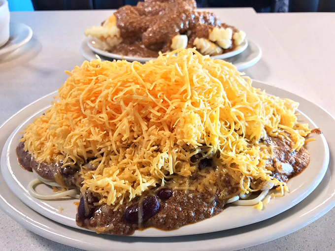 Behold the legendary five-way: a mountain of finely shredded cheddar atop Cincinnati's signature spiced chili. It's not a meal—it's an architectural achievement.