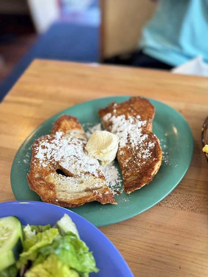Golden-crisp cinnamon French toast dusted with powdered sugar—proof that sometimes the simplest pleasures are worth traveling 8,000 feet above sea level for.