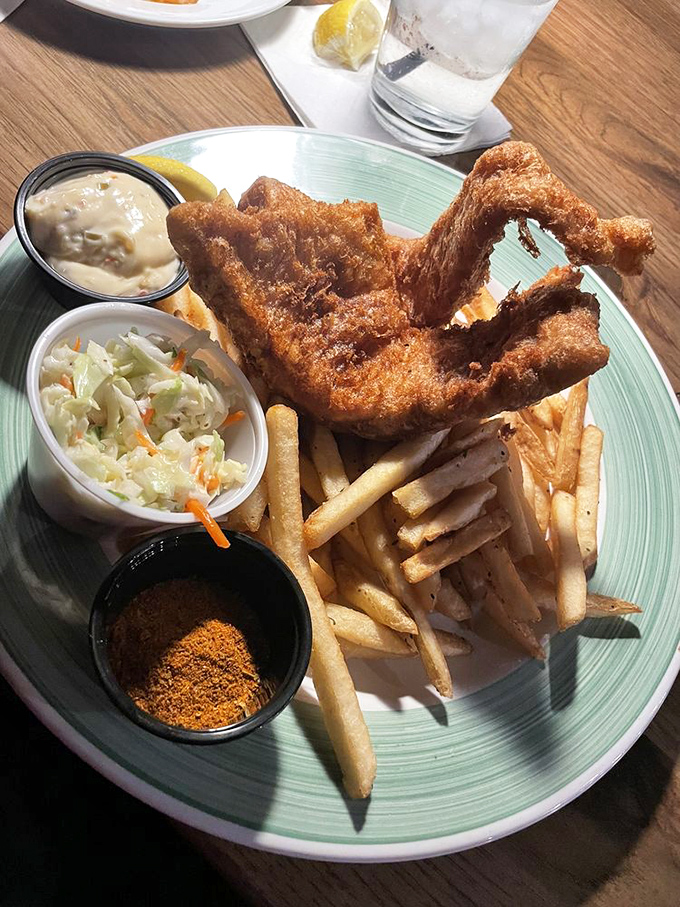 Golden-battered fish that shatters with each bite, alongside fries that achieve the perfect crisp-to-fluffy ratio. This isn't just dinner—it's edible architecture.