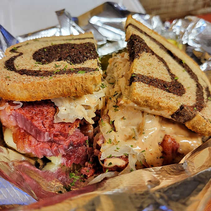 Sandwich architecture at its finest! Layers of pink corned beef, tangy sauerkraut, and melted Swiss create a masterpiece between perfectly grilled rye.