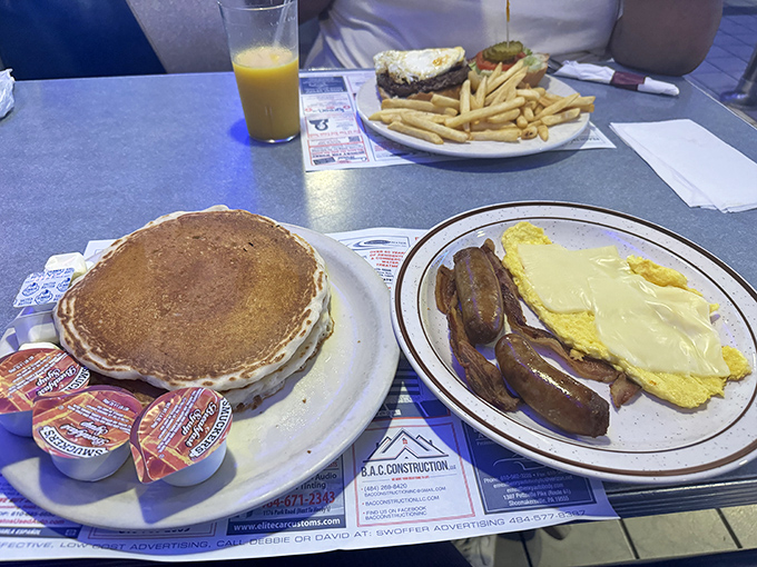 Breakfast diplomacy at its finest: pancakes that don't need a passport to transport you to happiness, alongside eggs and sausage that mean business.