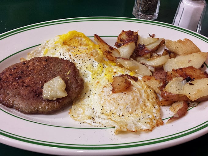 Sunny-side perfection meets golden home fries in a plate that whispers, "Go ahead, cancel your lunch plans. You'll be thinking about me all day."