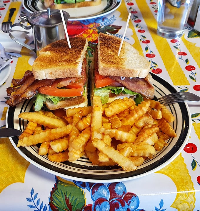 Sandwich architecture at its finest! This towering BLT creation demands a strategic approach—and possibly unhinging your jaw like a python.