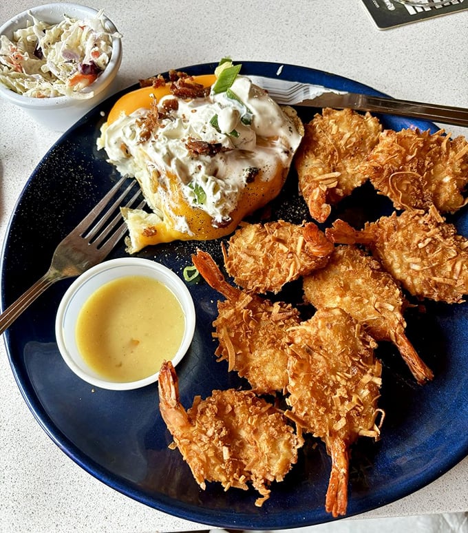Golden-brown coconut shrimp that look like they're wearing little tropical tuxedos. That dipping sauce is about to become your new best friend.