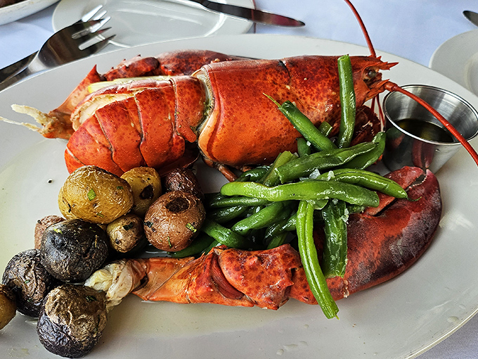 This isn't just dinner, it's a crustacean celebration – perfectly cooked lobster with seasonal vegetables that makes butter-dipping an art form.