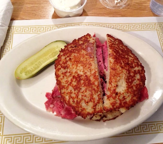 This isn't just a sandwich; it's a golden-brown masterpiece where crispy latke meets tender corned beef in a marriage that would make your bubbe weep with joy.
