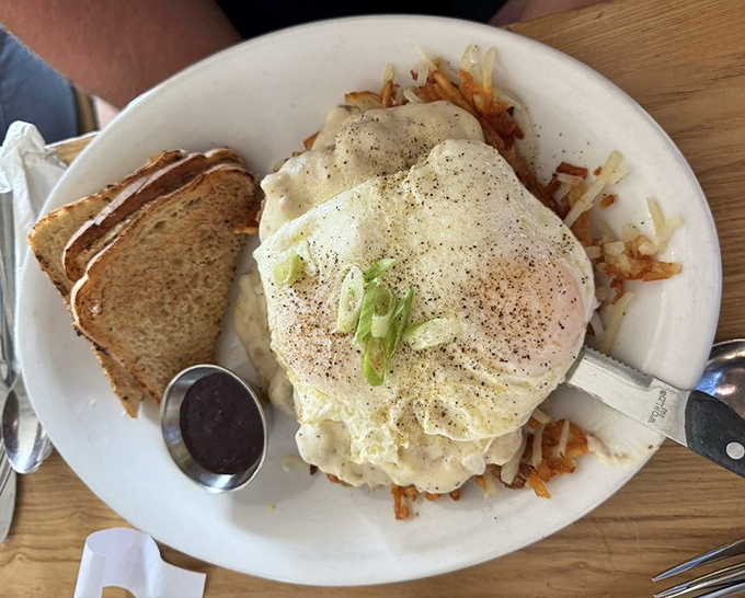 Behold the star attraction: country fried steak smothered in gravy with eggs and toast. Comfort food that doesn't just speak—it sings a full Broadway number.