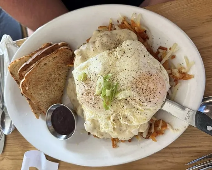 Behold the star attraction: country fried steak smothered in gravy with eggs and toast. Comfort food that doesn't just speak—it sings a full Broadway number.