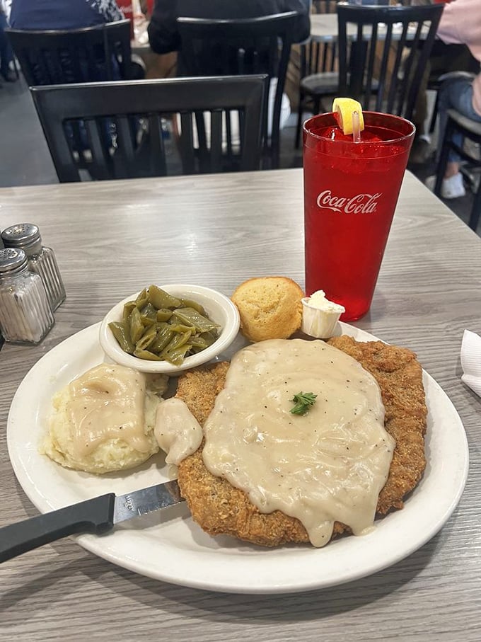Country fried steak that doesn't know it's 2023. That gravy blanket, those mashed potatoes, and green beans straight from someone's garden—comfort defined.