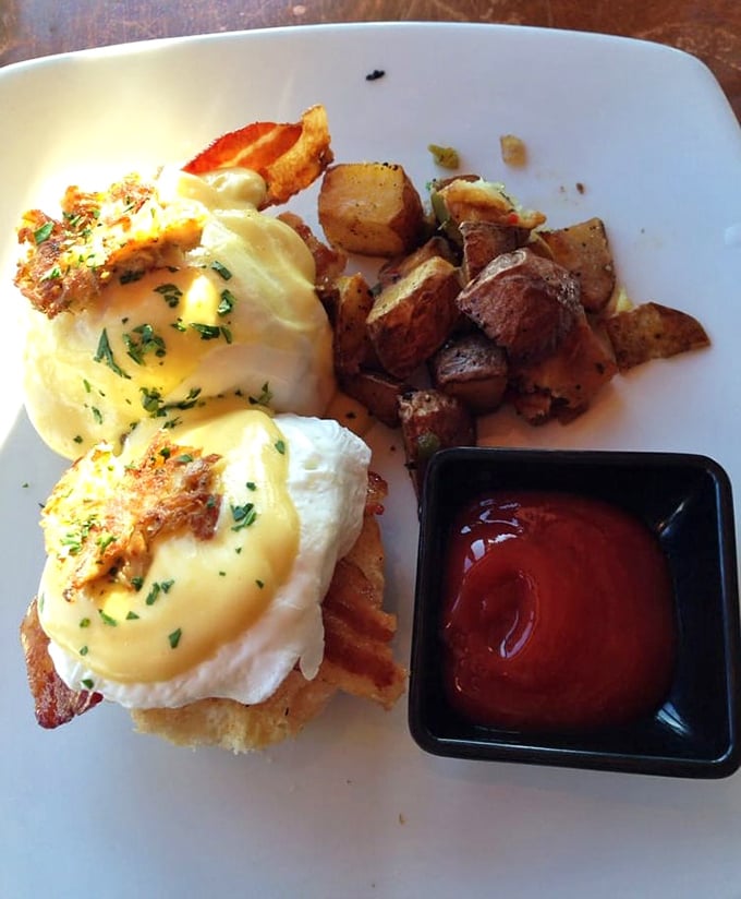 Benedict done right – perfectly poached eggs perched atop crispy goodness, with breakfast potatoes that demand equal attention.